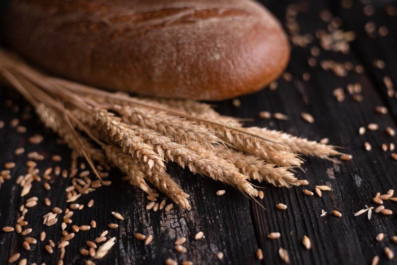 Whole Grain Bread on a Tree Table One Lies. Wheat Grains Stock Photo ...
