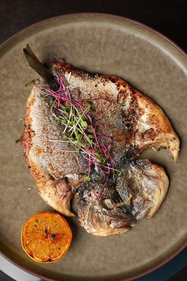 Whole Grilled Spicy Fish Served for Dinner on Restaurant Table Stock ...