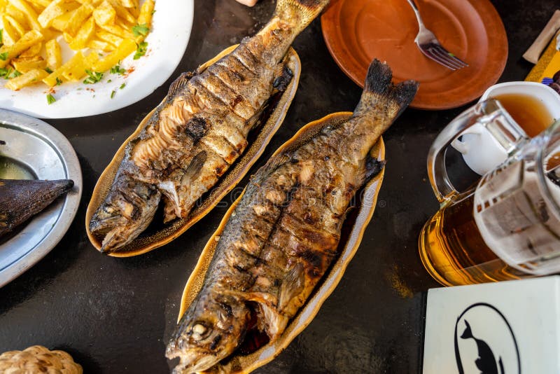 Whole Grilled Trout Fish with Head on the Table Stock Photo - Image of ...