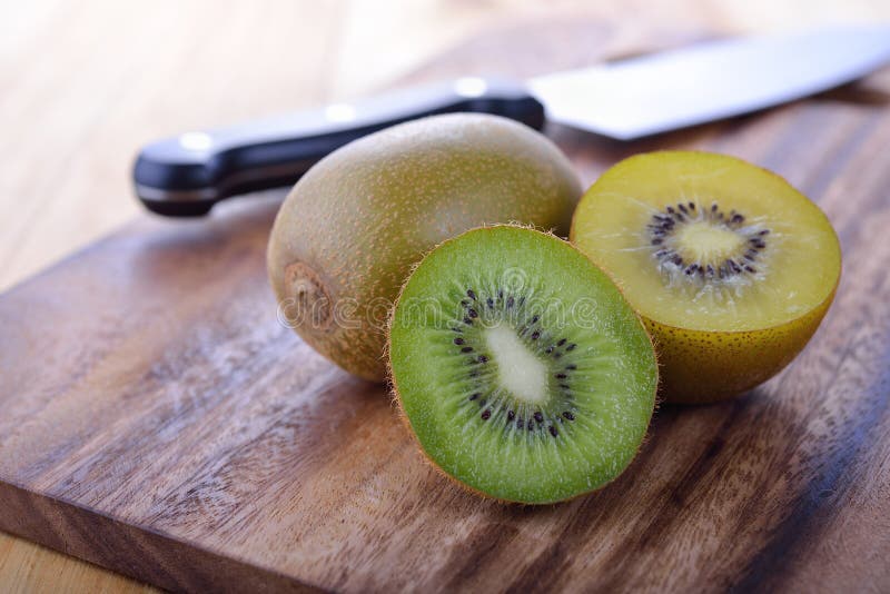 Whole and Haft Cut Green and Golden Kiwi on Board Stock Photo - Image ...