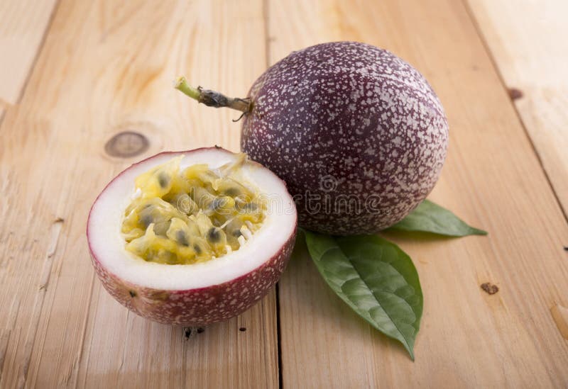 Whole and Haft Cut Passion Fruit on Wooden Table Stock Image - Image of ...
