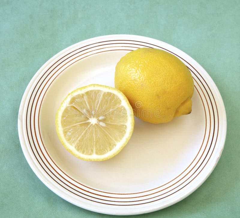 Whole and Half Lemon on Plate Stock Photo - Image of fruits, citrus ...