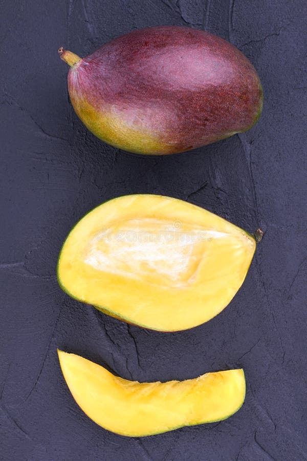 Half cut and whole mango stock image. Image of studio - 12045299