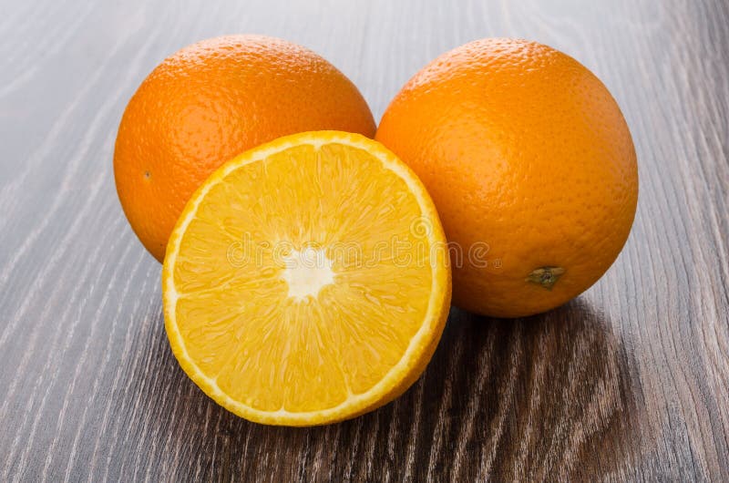 Whole and Half of Ripe Oranges on Wooden Table Stock Photo - Image of ...