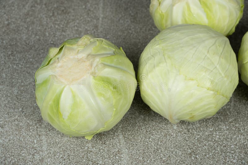 Whole Heads of Fresh White Cabbage on a Gray Stone Background Close-up ...