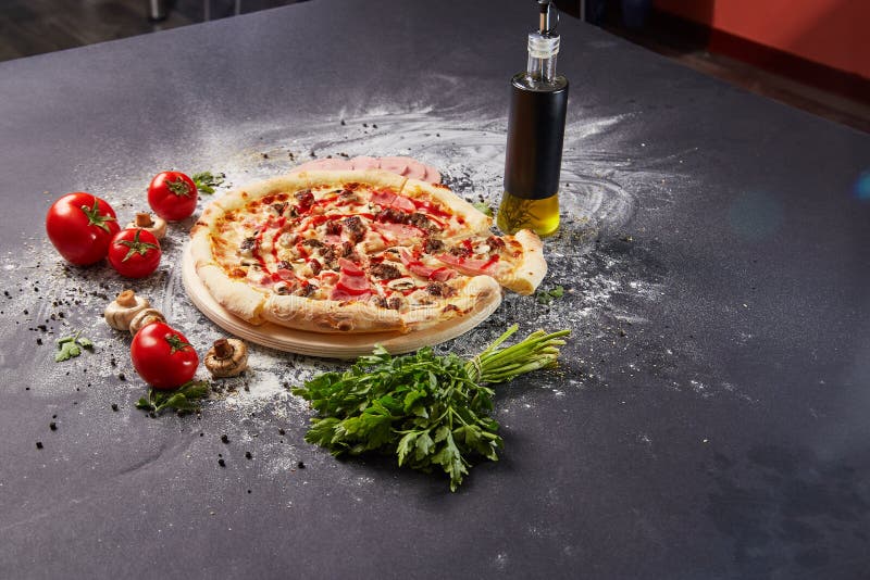Whole Italian Pizza on Wood Table with Ingredients Stock Photo - Image ...