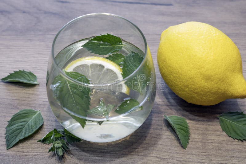 Whole Lemon and Lemon Water with Mint and Mint Leaves on the Table ...