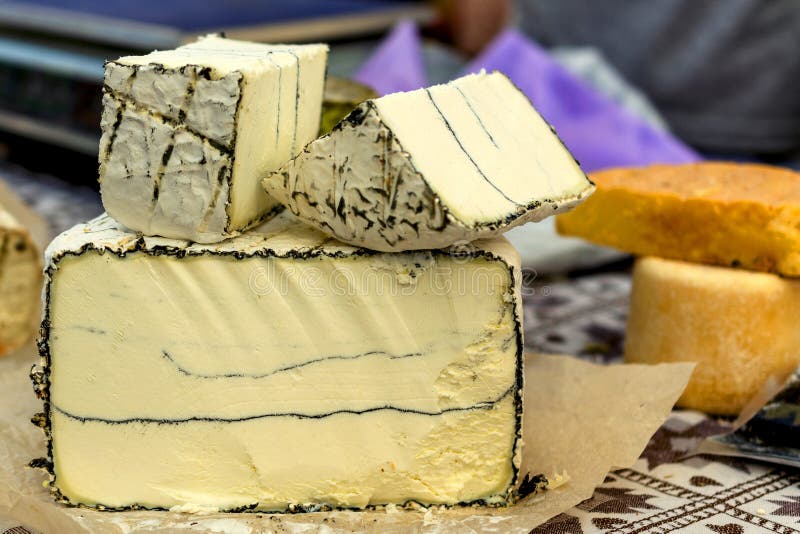 Whole and Notched Heads of Different Kinds of Cheese on Market C Stock ... Whole and Notched Heads of Different Kinds of Cheese on Market C Stock ...