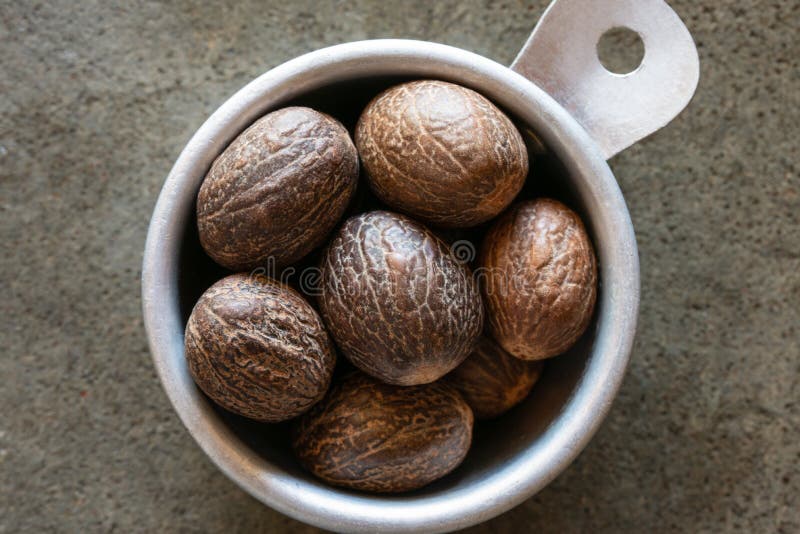 Whole Nutmeg in a Bowl stock photo. Image of ingredient - 169630662