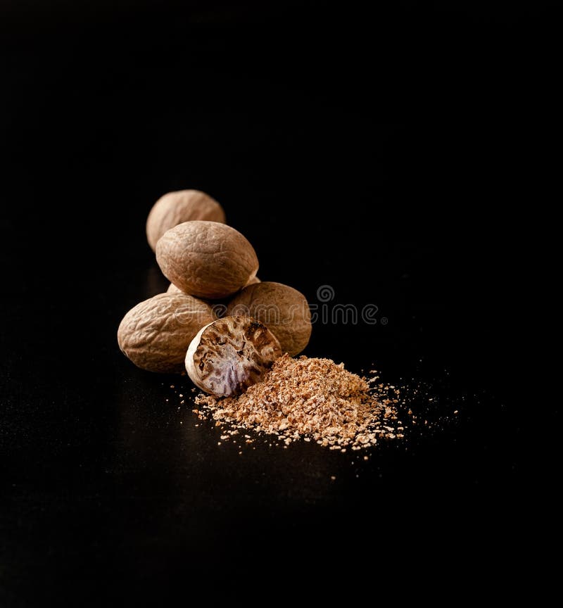 Whole Nutmeg Nuts and Nutmeg Powder in a Black Background Stock Image ...