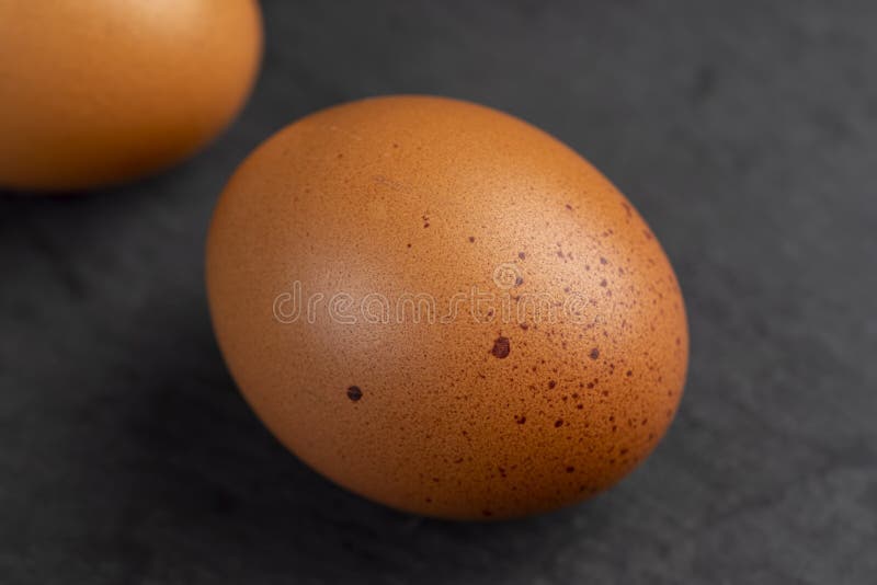 A Whole Orange Chicken Egg Close-up on the Table Stock Photo - Image of ...