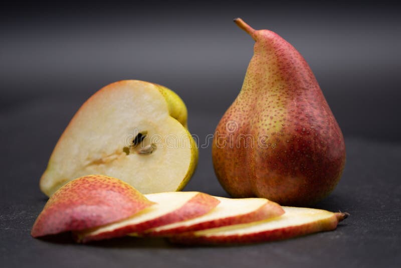 Whole Pears and Slices of Pear on Black Stock Image - Image of fruit ...
