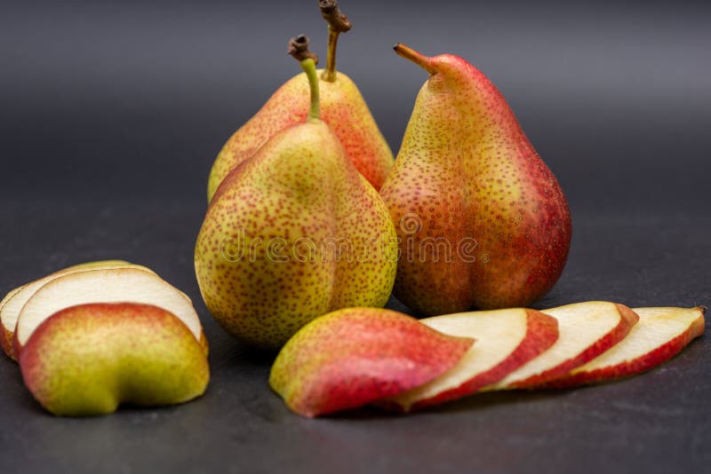 Whole Pears and Slices of Pear on Black Stock Photo - Image of sliced ...