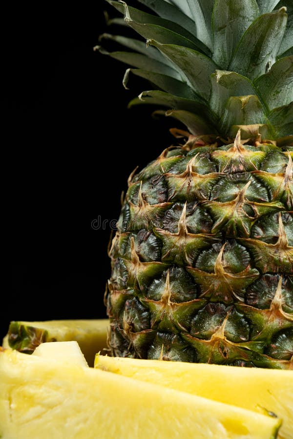Whole Pineapple and Cut into Pieces on a Black Background Close-up ...