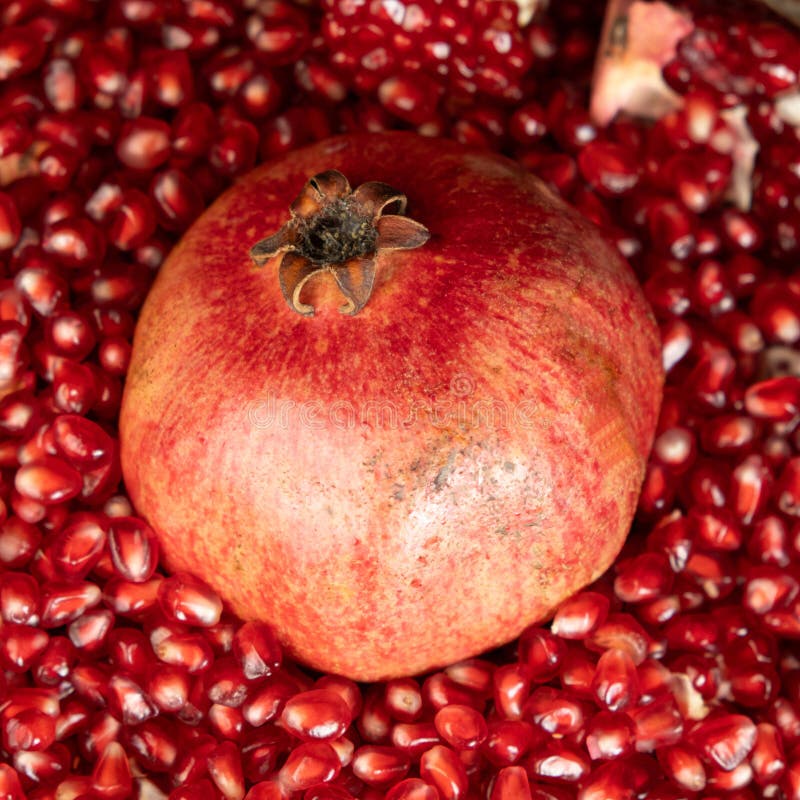 A Whole Pomegranate and Pomegranate Grains Close-up. Stock Photo ...