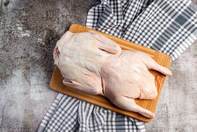 Whole Raw Duck on a Rectangular Cutting Wooden Board on a Dark Grey ...
