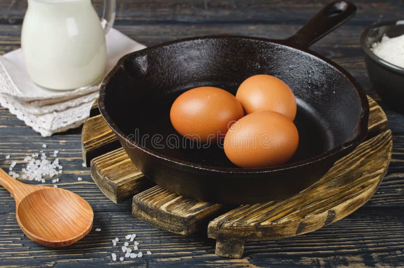 Whole Raw Eggs in a Pan on a Wooden Table Stock Image - Image of milk ...