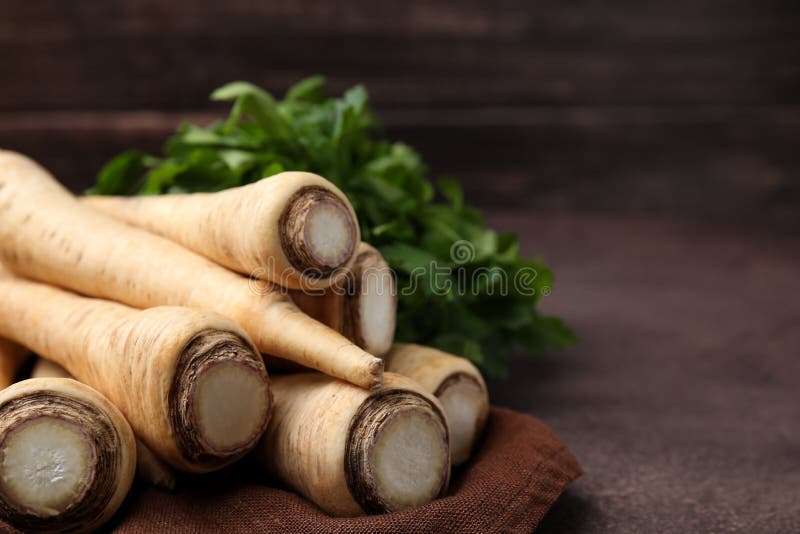 Whole Raw Parsley Roots and Fresh Herb on Brown Table, Closeup. Space ...