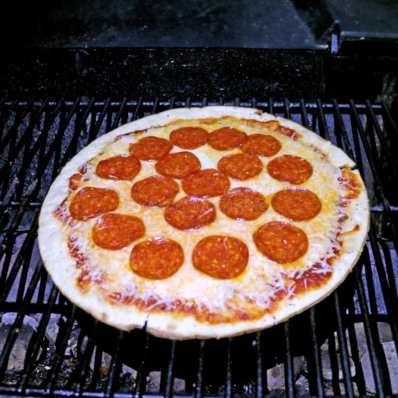 Whole Raw Pepperoni Pizza on a Grilling Machine Stock Image - Image of ...
