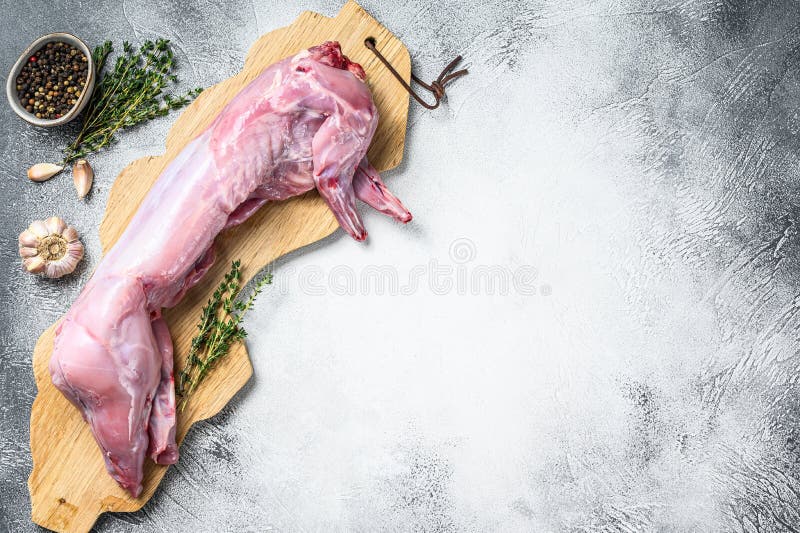 Whole Raw Rabbit on a Cutting Board. Gray Background. Top View Stock ...
