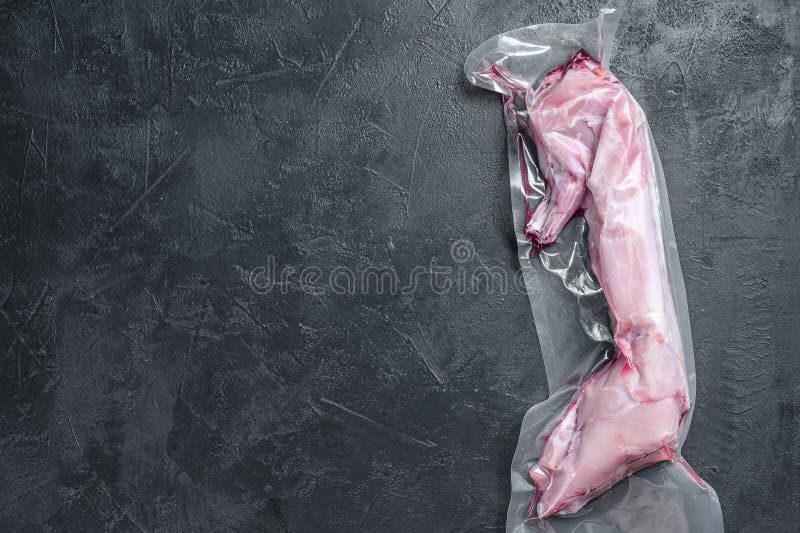 A Whole Raw Rabbit in a Vacuum Package. Black Background. Top View ...