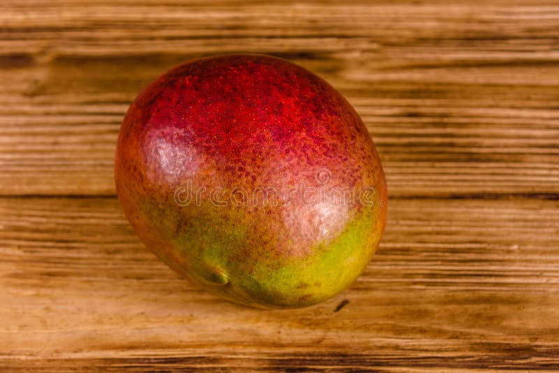 Whole Red Mango Fruit on a Wooden Table Stock Photo - Image of fruit ...