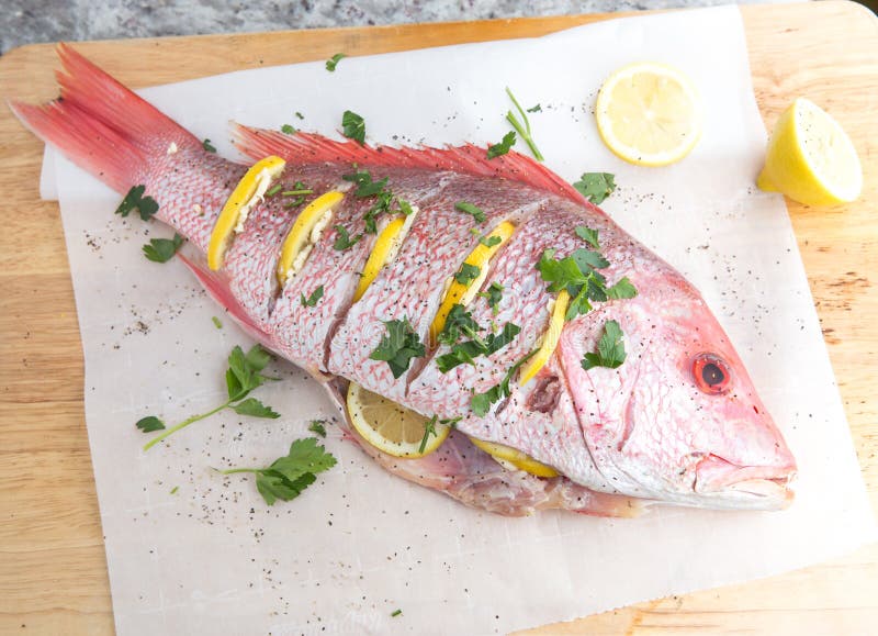 Whole Red Snapper with Lemon Slices and Parsley Stock Image - Image of ...