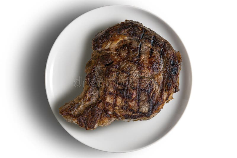 Whole Rib Eye Beef on a Round White Plate Stock Photo - Image of white ...