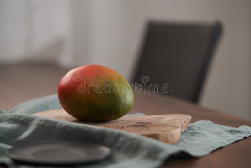 Whole Ripe Red Mango on Olive Wood Board Stock Photo - Image of ...
