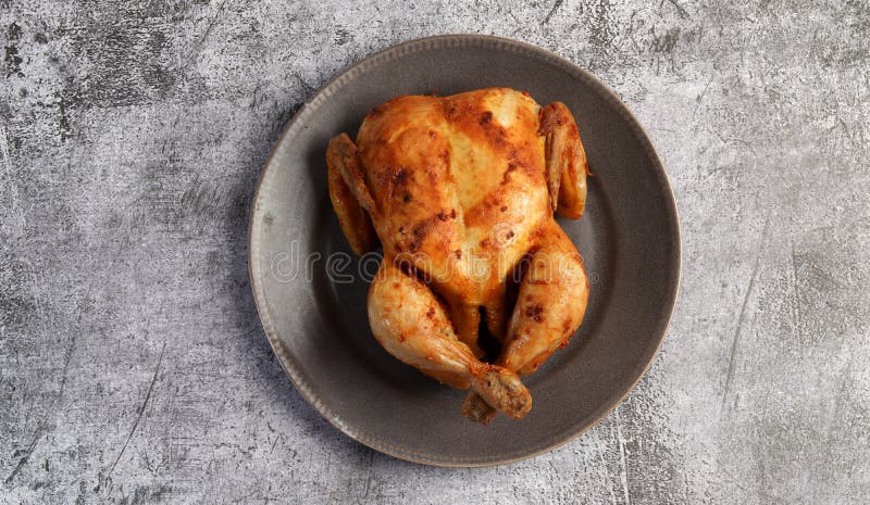 Whole Roast Chicken on a Round Plate on a Dark Gray Background Stock ...
