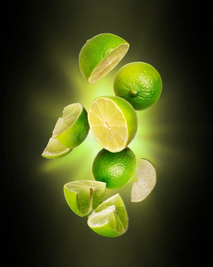 Whole and Sliced Fresh Lime in the Air with Flash of Light in the Dark ...
