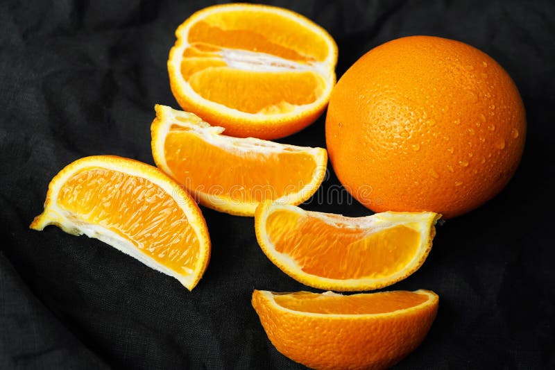 Whole and Sliced Oranges on a Dark Background Stock Photo - Image of ...