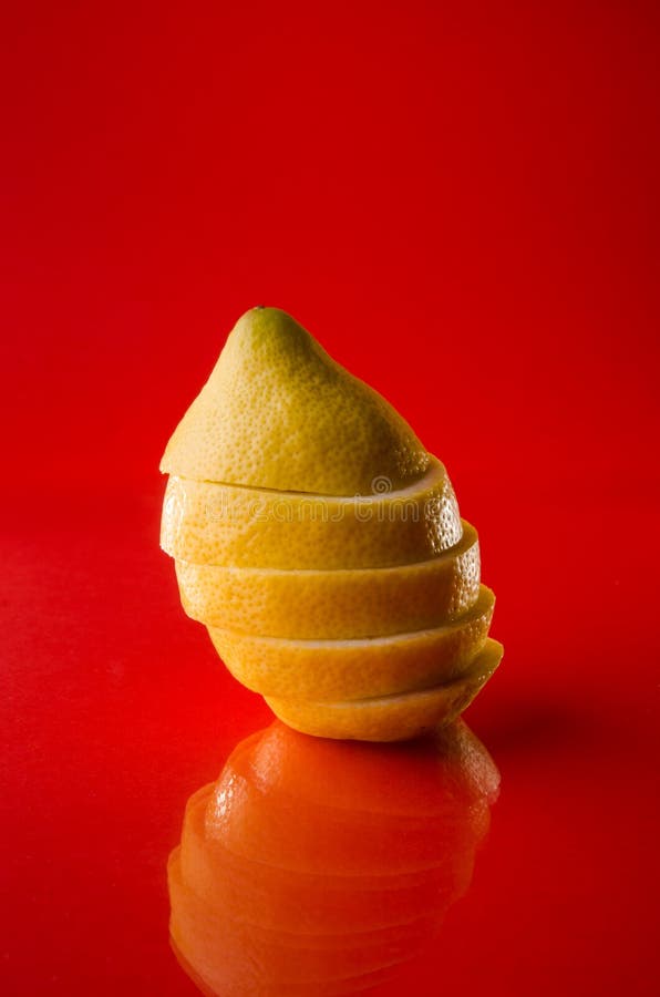 Whole Sliced Lemon on Red Background, Vertical Shot Stock Image - Image ...