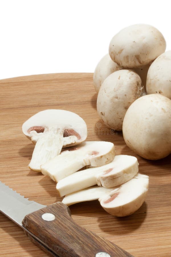 Whole and Sliced Mushrooms with Knife on Wooden Board Stock Photo ...
