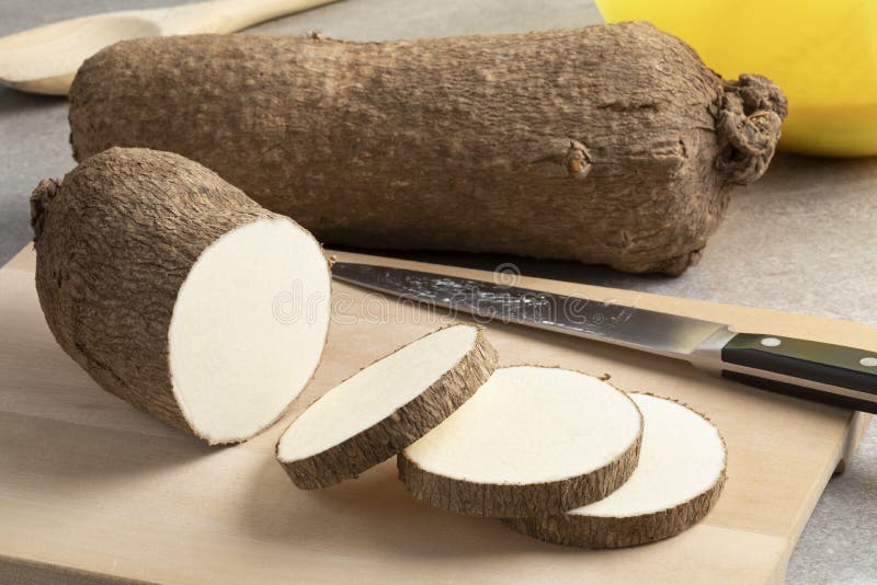 Whole and Sliced Raw African Yam on a Cutting Board Stock Photo - Image ...