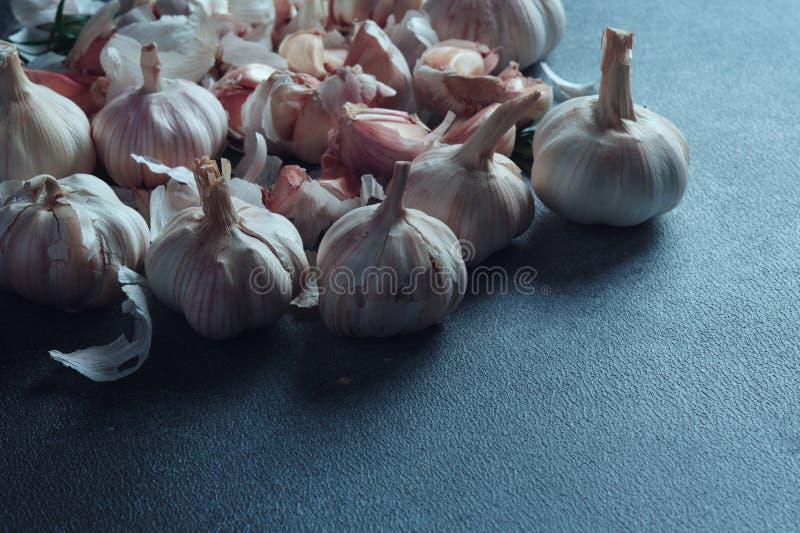 Whole and Split Garlic Bulbs on Dark Surface. Assortment of Fresh ...