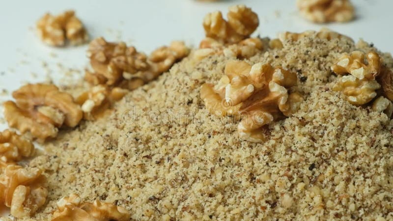 Whole Walnut Halves Poured on Crushed Walnut Kernels Flour Slow Motion ...