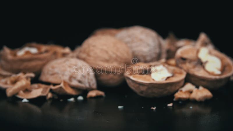 Whole Walnut Halves Poured on Crushed Walnut Kernels Flour Slow Motion ...