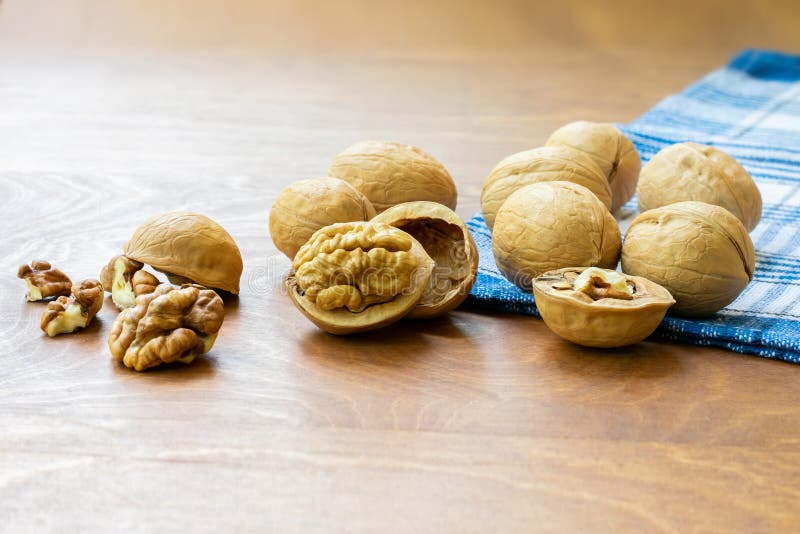 Whole Walnuts and Walnut Kernel Halves without Shell on a Dark Wooden ...