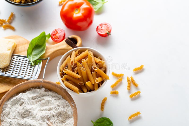 Whole Wheat Penne Pasta and Flour on Light Table Stock Image - Image of ...