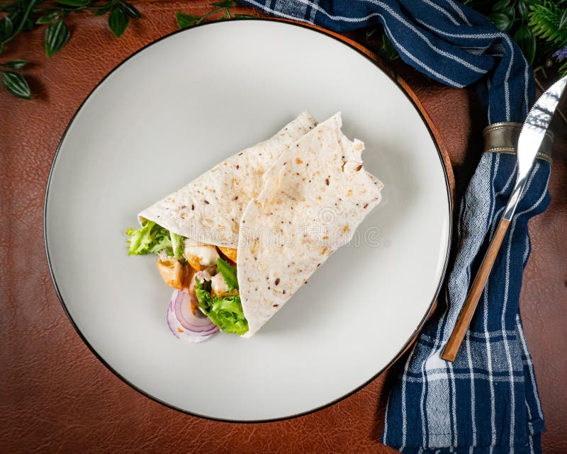 Wholegrain Tortilla Wraps with Vegetables and Chicken on a Plate Stock ...