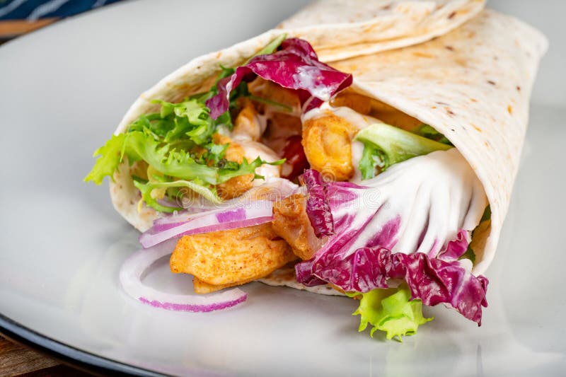 Wholegrain Tortilla Wraps with Vegetables and Chicken on a Plate Stock ...