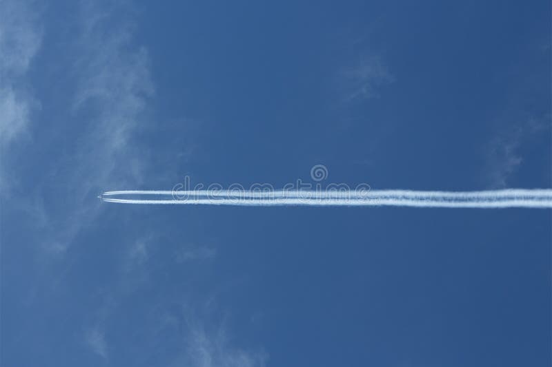 Distant Plane Leaving a Contrail in the Sky. Stock Photo - Image of ...
