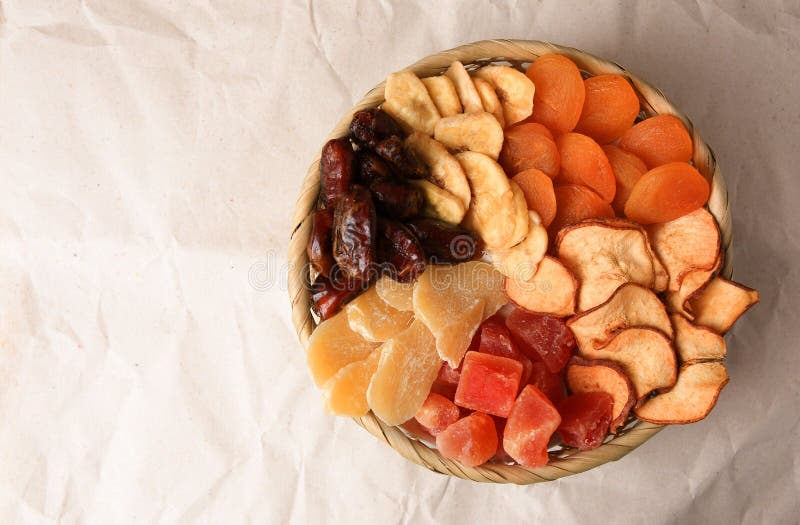 Wicker Basket with Different Dried Fruits on Paper, Top View. Space for ...