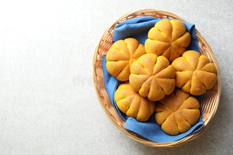 Wicker Basket with Tasty Pumpkin Shaped Buns on Light Table, Top View ...