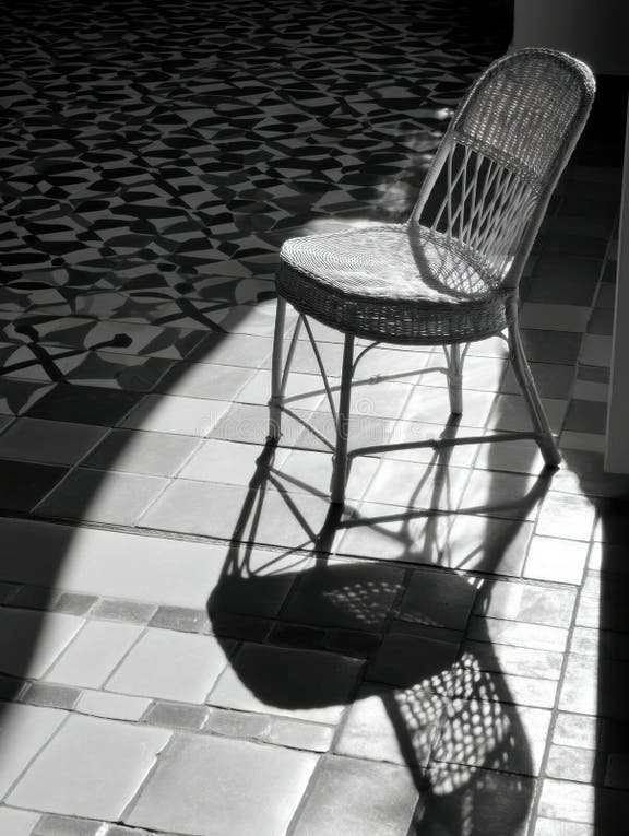 Wicker Chair Casting Intricate Shadow Patterns Over Patterned Tiled ...