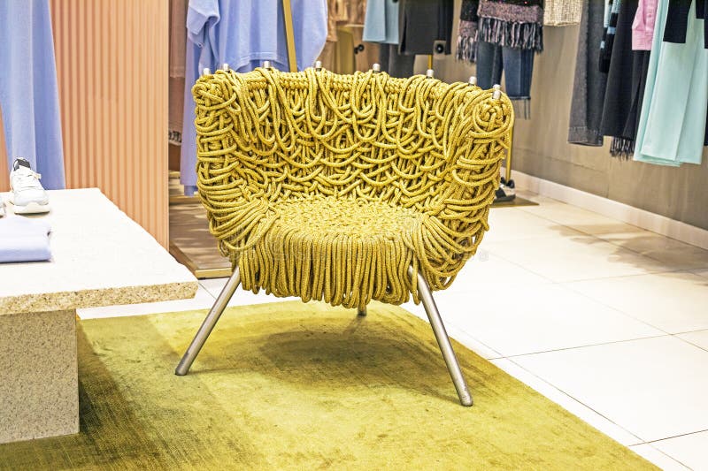 Wicker Chair with Yellow Gold Threads and Fringe in an Interior with ...