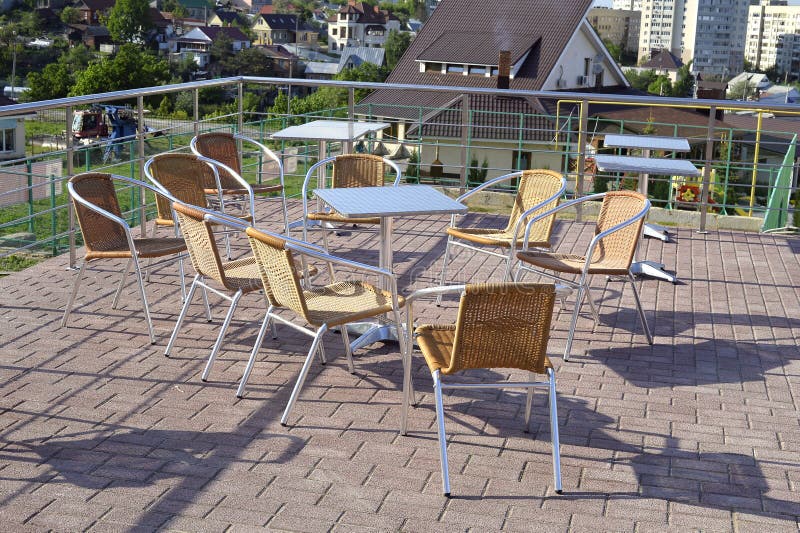 Wicker Chairs with Metal Legs and Racks are in an Open Cafe Area Stock ...