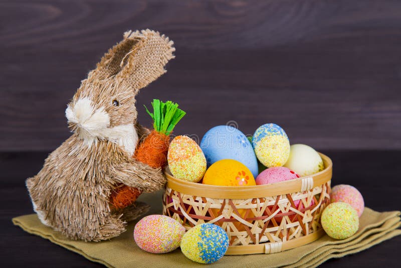 Wicker Easter Bunny with Easter Eggs in Basket on Dark Wooden Ba Stock ...
