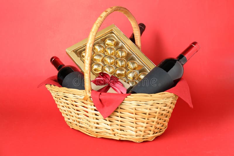 Wicker Gift Basket with Wine on Red Background Stock Photo - Image of ...
